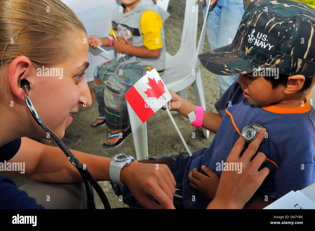 Project Hope volunteer Mary Beth Wargo checks the pulse of a child ...