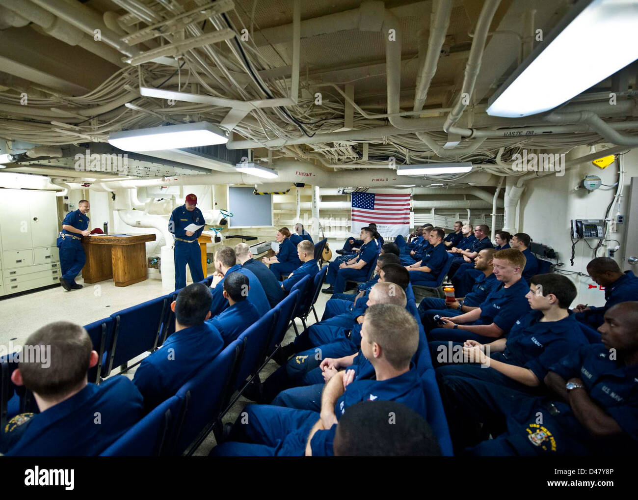 A Senior Chief Damage Controlman briefs Sailors aboard ship on ...