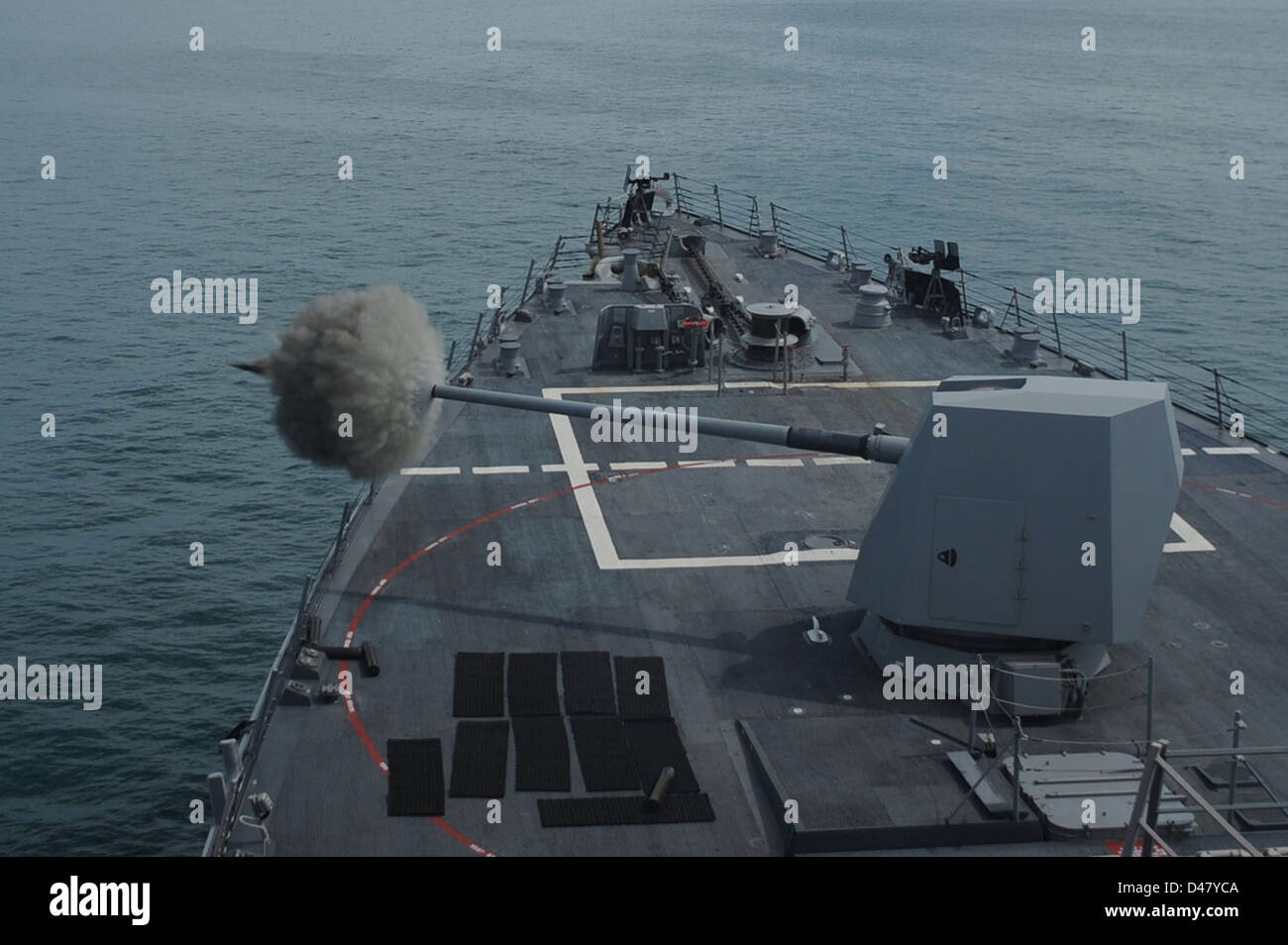 The USS Jason Dunham (DDG 109) fires a 5-inch gun during a military ...