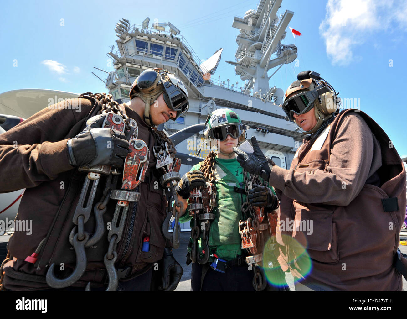 Sailors aboard a U.S. Navy vessel conduct a debriefing following the ...