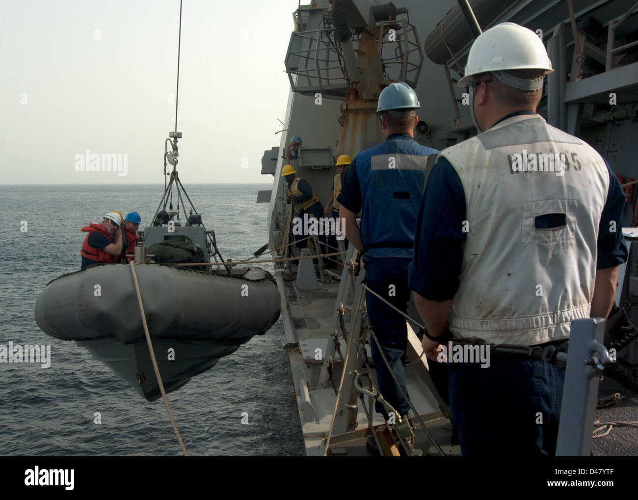 Sailors lower rigid hull inflatable boat hi-res stock photography and ...
