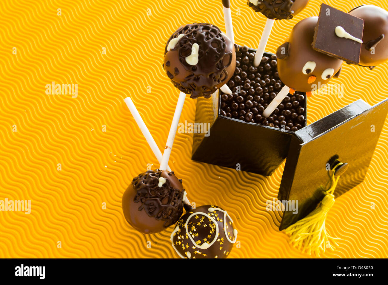 Gourmet chocolate cake pops decorated for graduation party Stock Photo ...