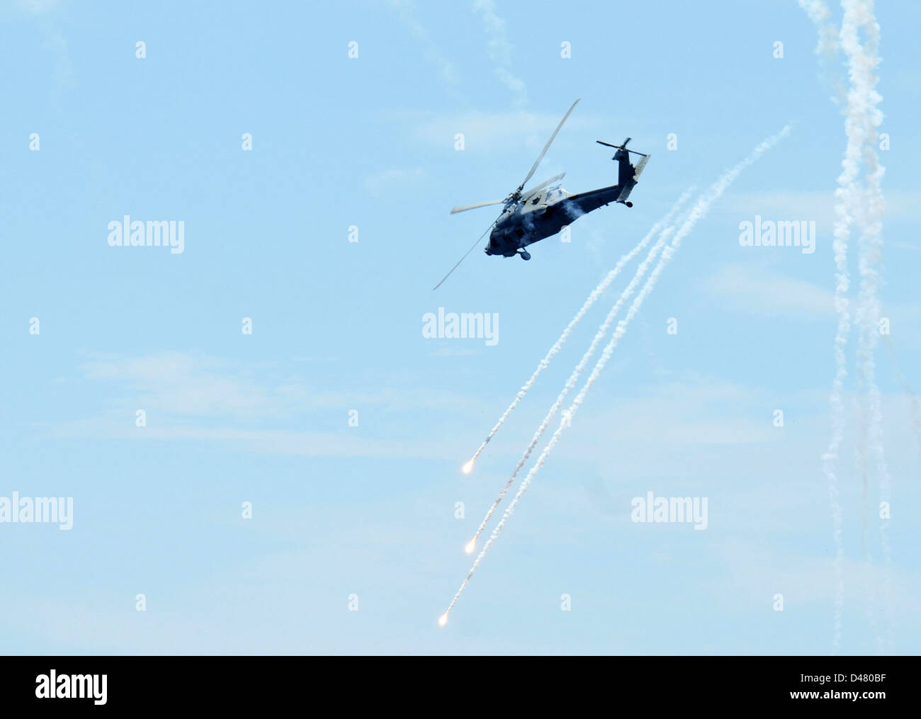 A U.S. Navy helicopter fires flares during a training exercise in the ...