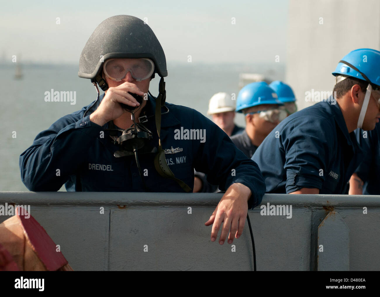 A Sailor on a U.S. Navy vessel performs duties as a sound-powered phone ...