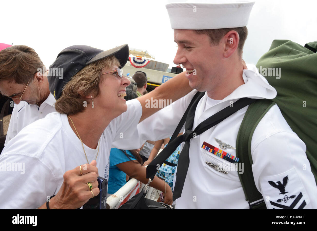 A Sailor reunites with his family during a homecoming at Naval Station ...