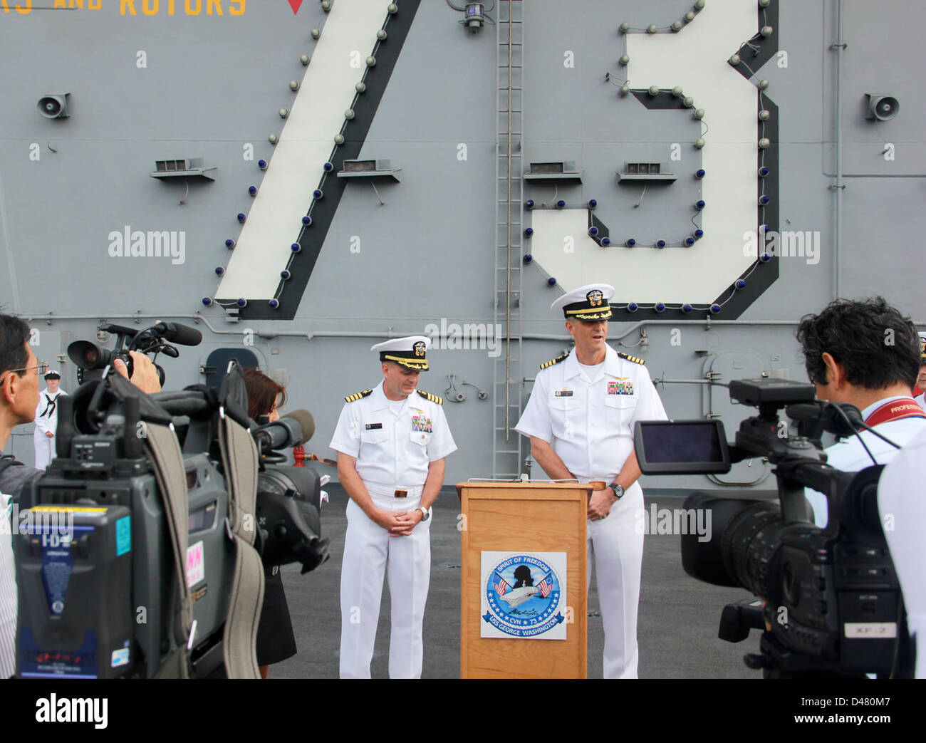 The departing and incoming Commanding Officers (CO) of USS George ...