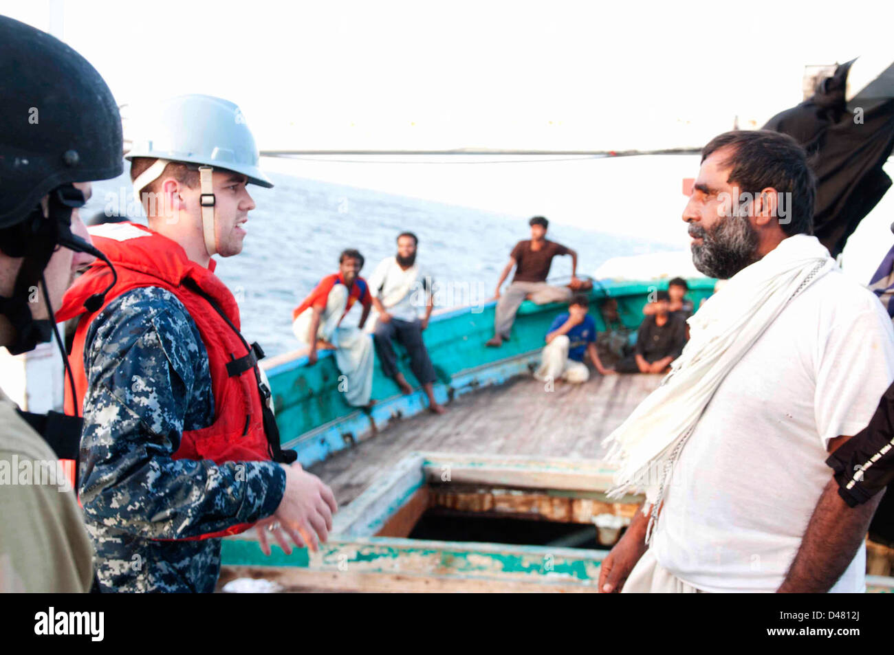 A Sailor in the Arabian Sea engages in a conversation with a fellow ...