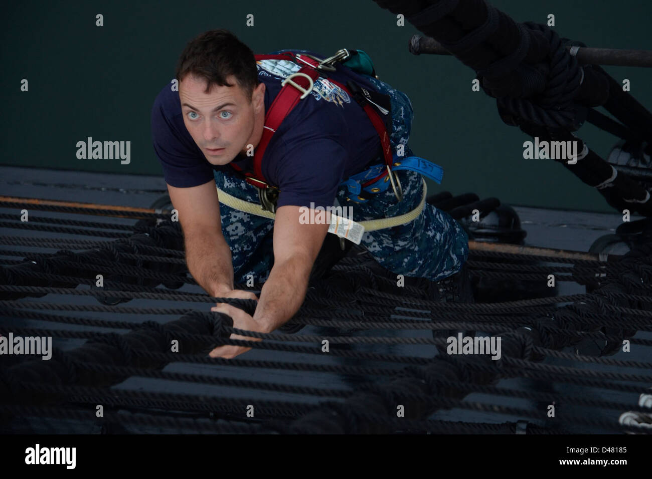 A Chief Select climbs the main mast of a Navy ship as part of a ...