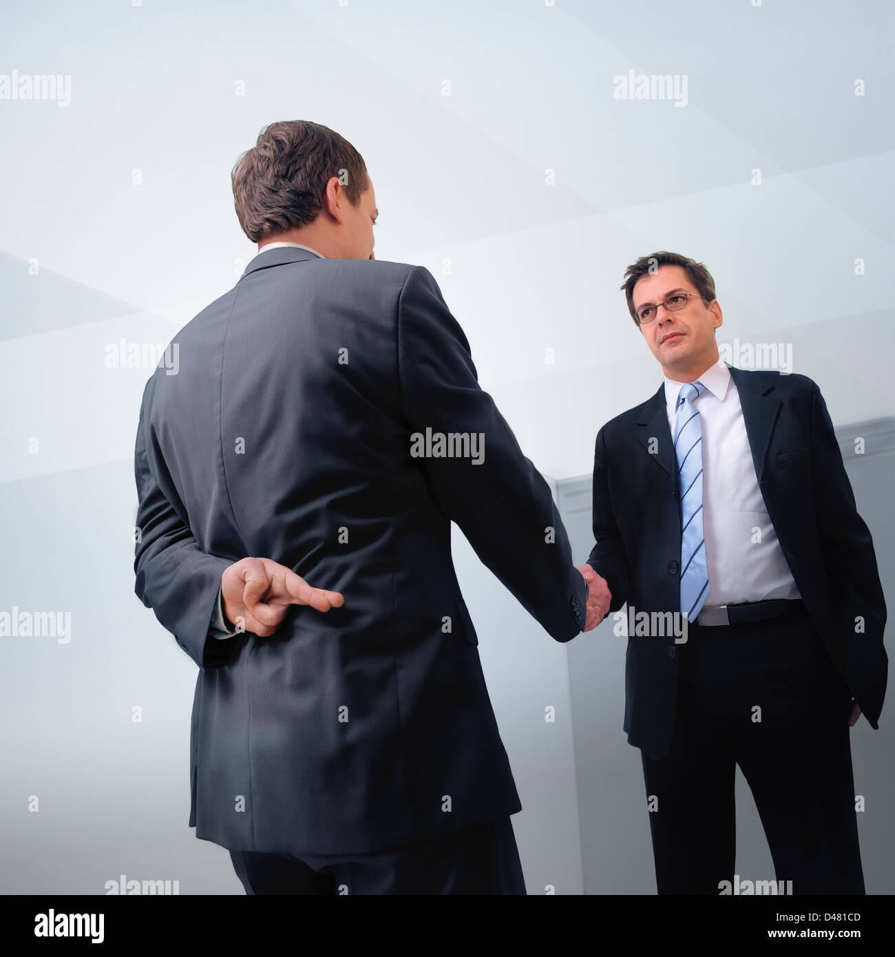 Crossed fingers shaking hands hi-res stock photography and images - Alamy