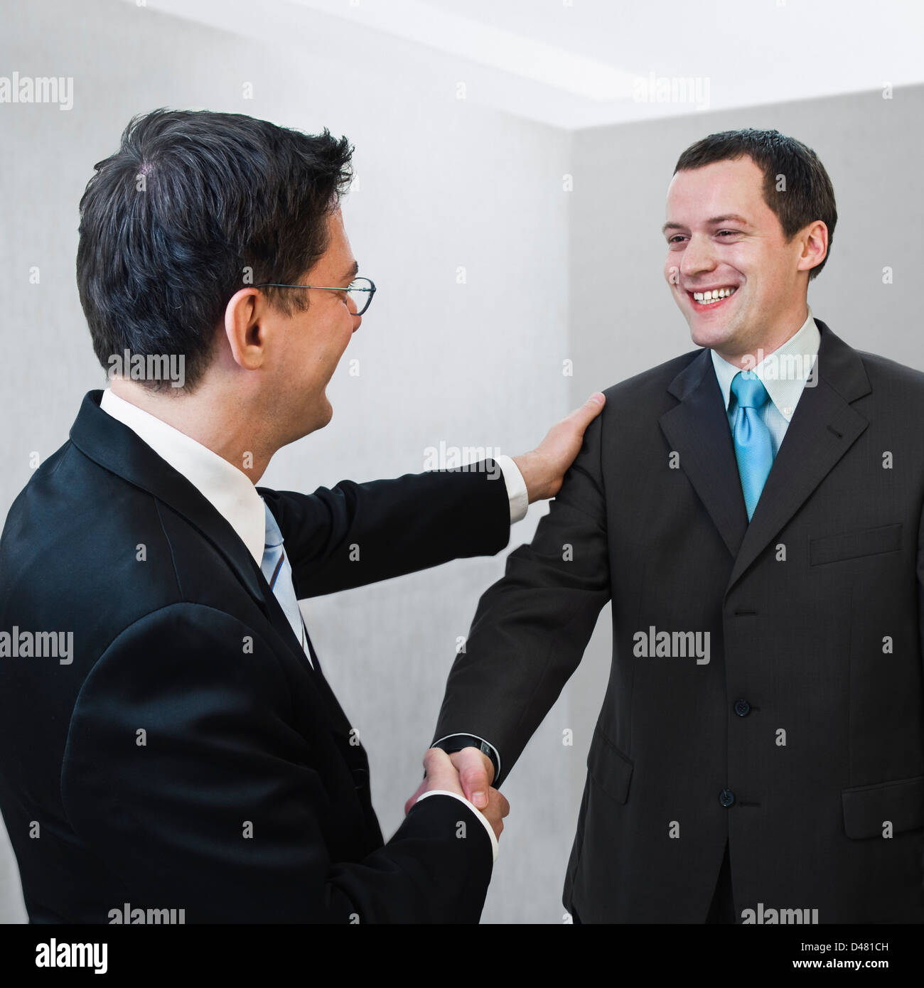 a warm friendly handshake between two businessmen, or a manager telling ...