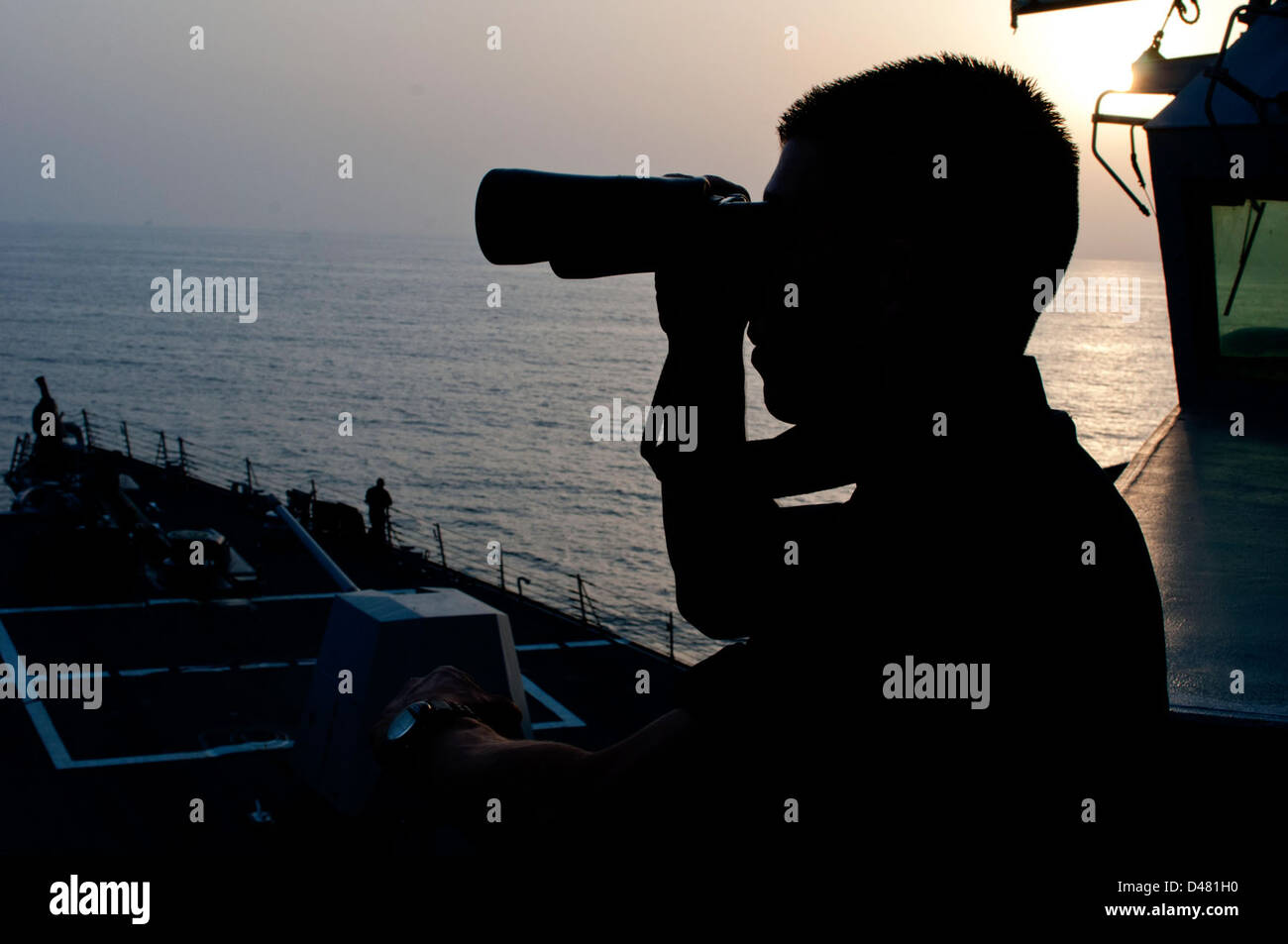 A Sailor stands watch as a lookout aboard the USS Winston Churchill ...