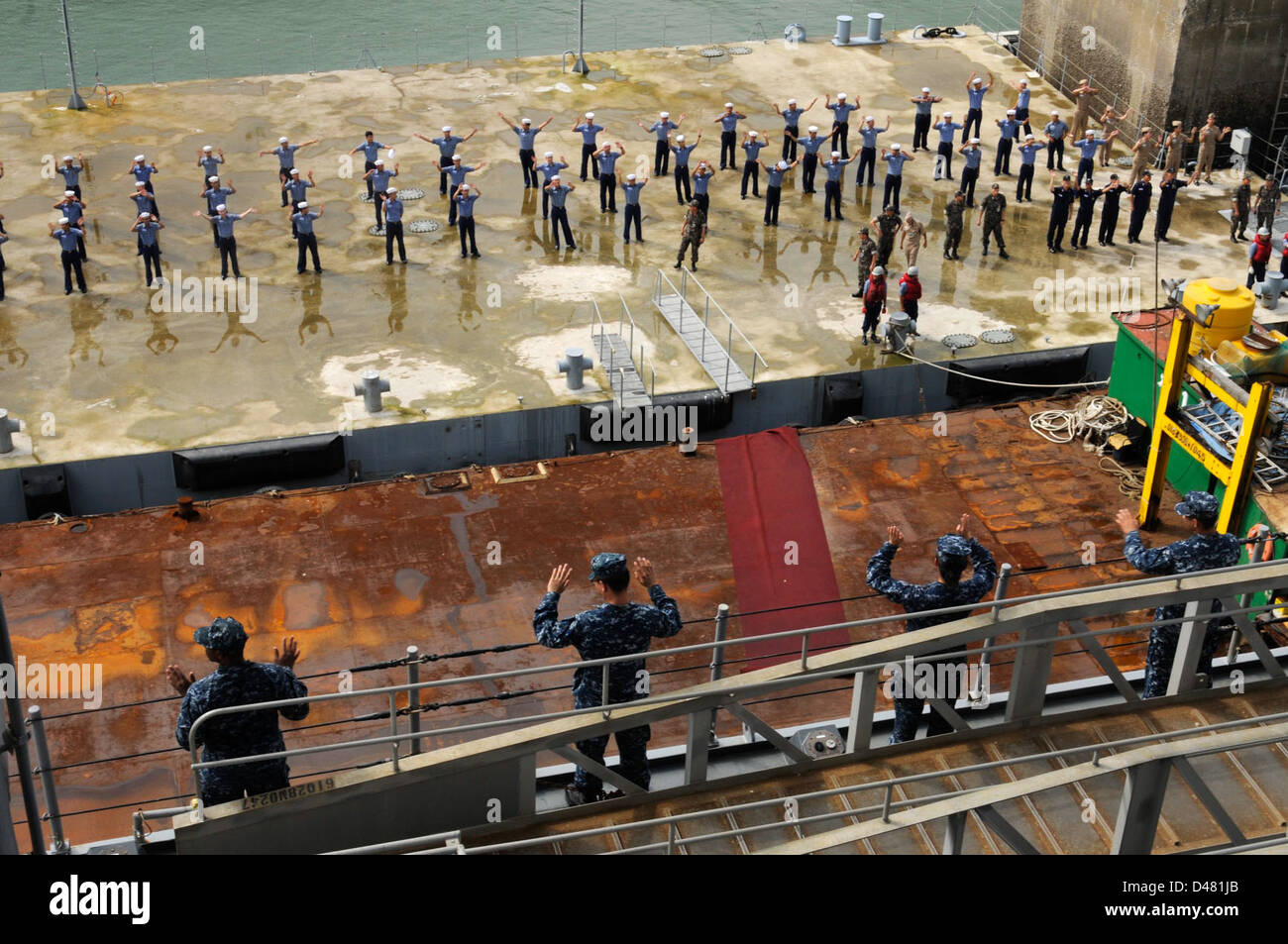 U.S. Navy sailors aboard USS Blue Ridge (LCC 19) wave to Republic of Korea Navy sailors on a ...