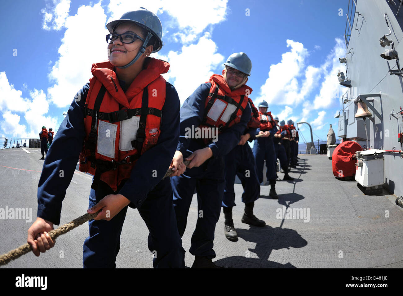 A Sailor participates in replenishment at sea, throwing a line to ...