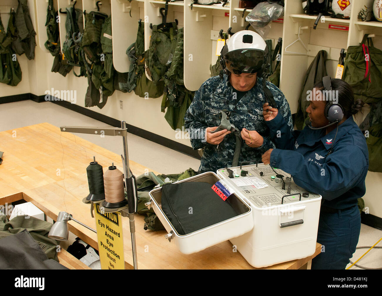 Sailors aboard a U.S. Navy ship practice using oxygen masks as part of ...