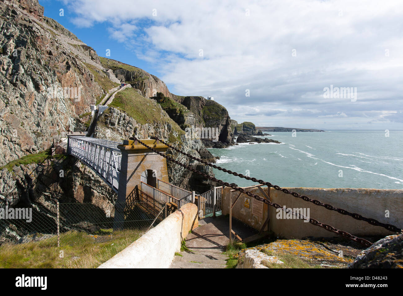 The iron suspension bridge that connects South Stack lighthouse to the ...