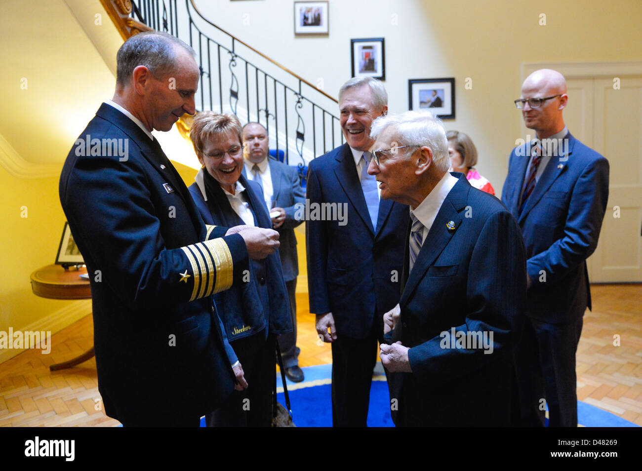 The Chief of Naval Operations (CNO) receives a challenge coin as a ...