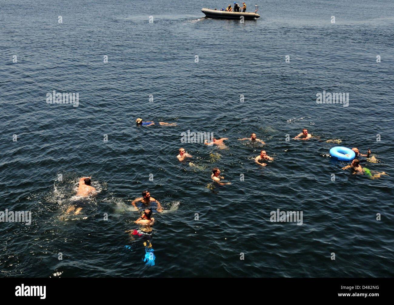 Sailors aboard the USS Underwood participate in a swim call in the ...