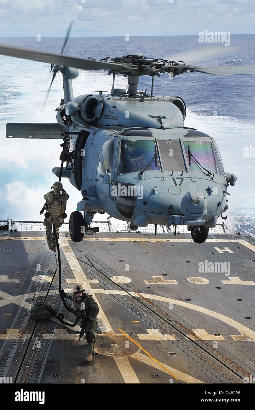 Sailors fast rope onto the flight deck Stock Photo - Alamy