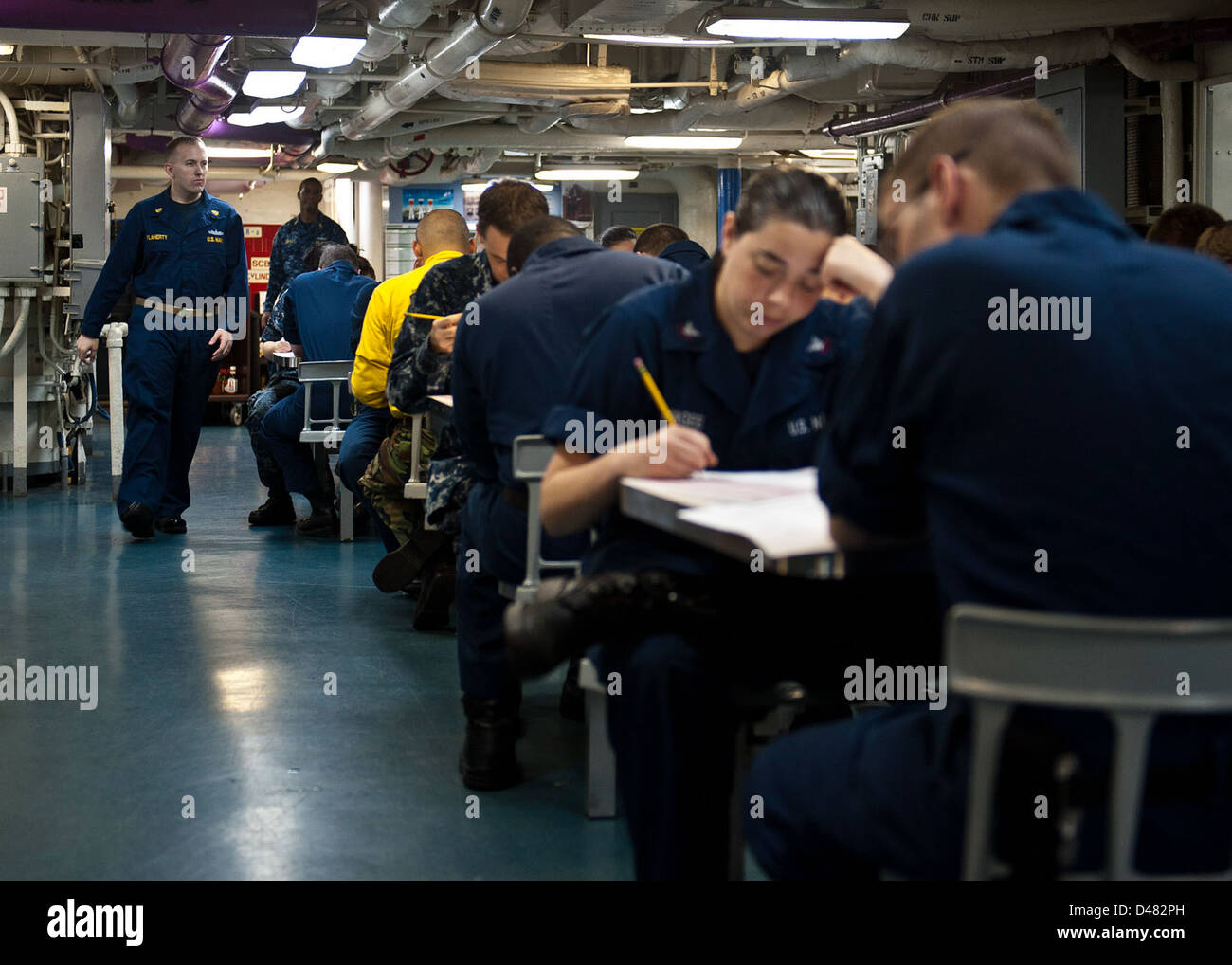 Sailors aboard a U.S. Navy aircraft carrier in the Arabian Sea take the ...