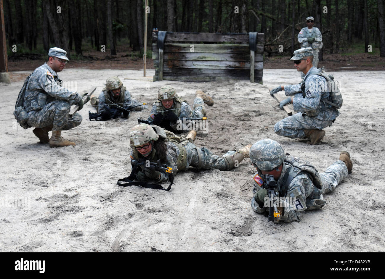 Navy and Air Force personnel practice crawling under Constantine wire ...