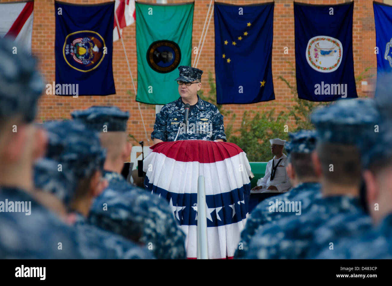 A Navy captain delivers a speech at a submarine base, addressing ...