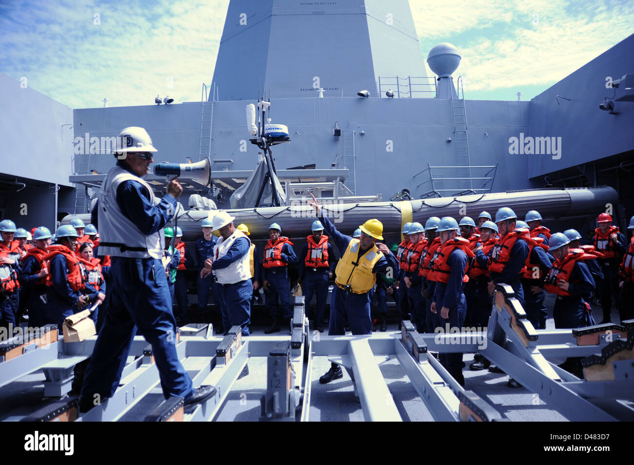 Sailors aboard a U.S. Navy ship receive a safety briefing as part of ...