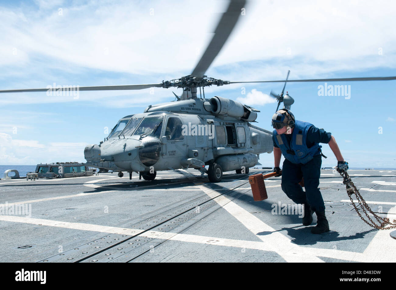 A Sailor prepares to operate a Sea Hawk helicopter aboard USS Mustin ...