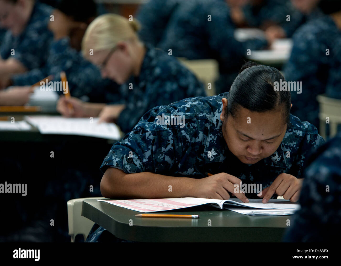Sailors aboard a U.S. Navy ship take the advancement exam, testing ...