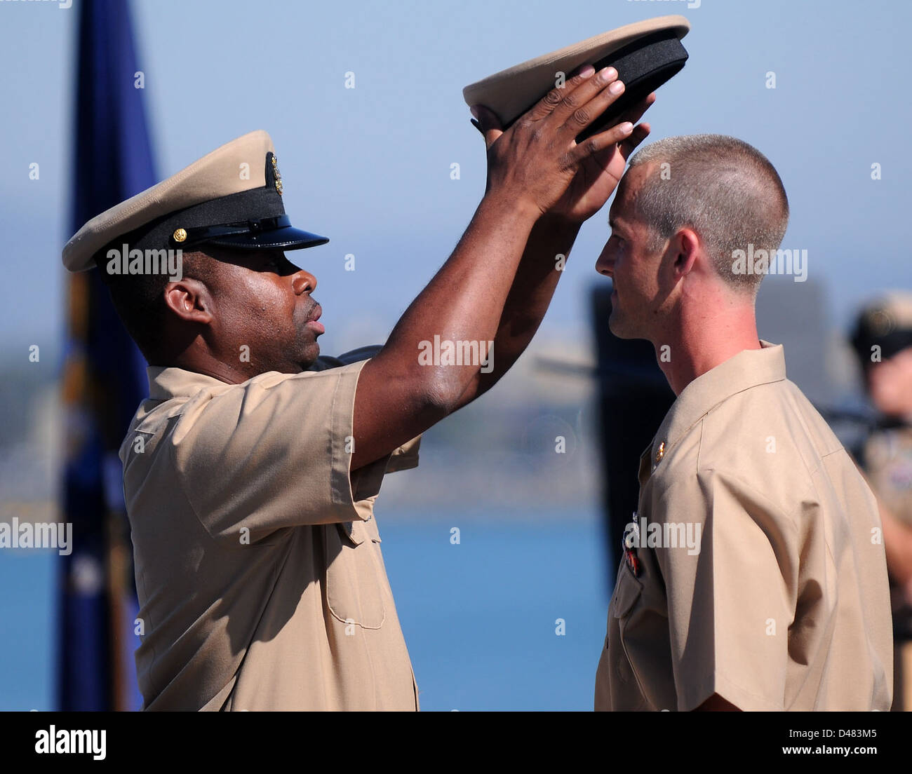 A new chief receives their combination cover during a ceremony in ...