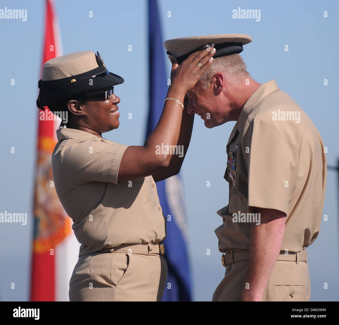 A new Navy chief receives his combination cover during a ceremony in ...