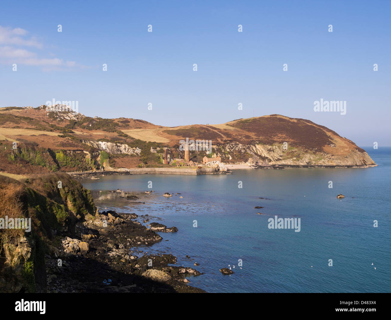 View across bay to derelict Porth Wen brickworks on Isle of Anglesey ...