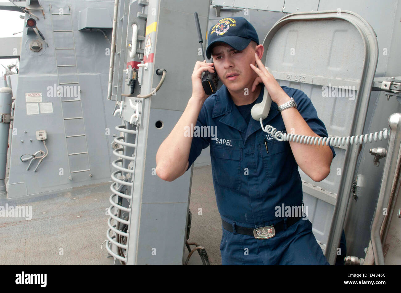 Sailor uses a satellite phone Stock Photo - Alamy