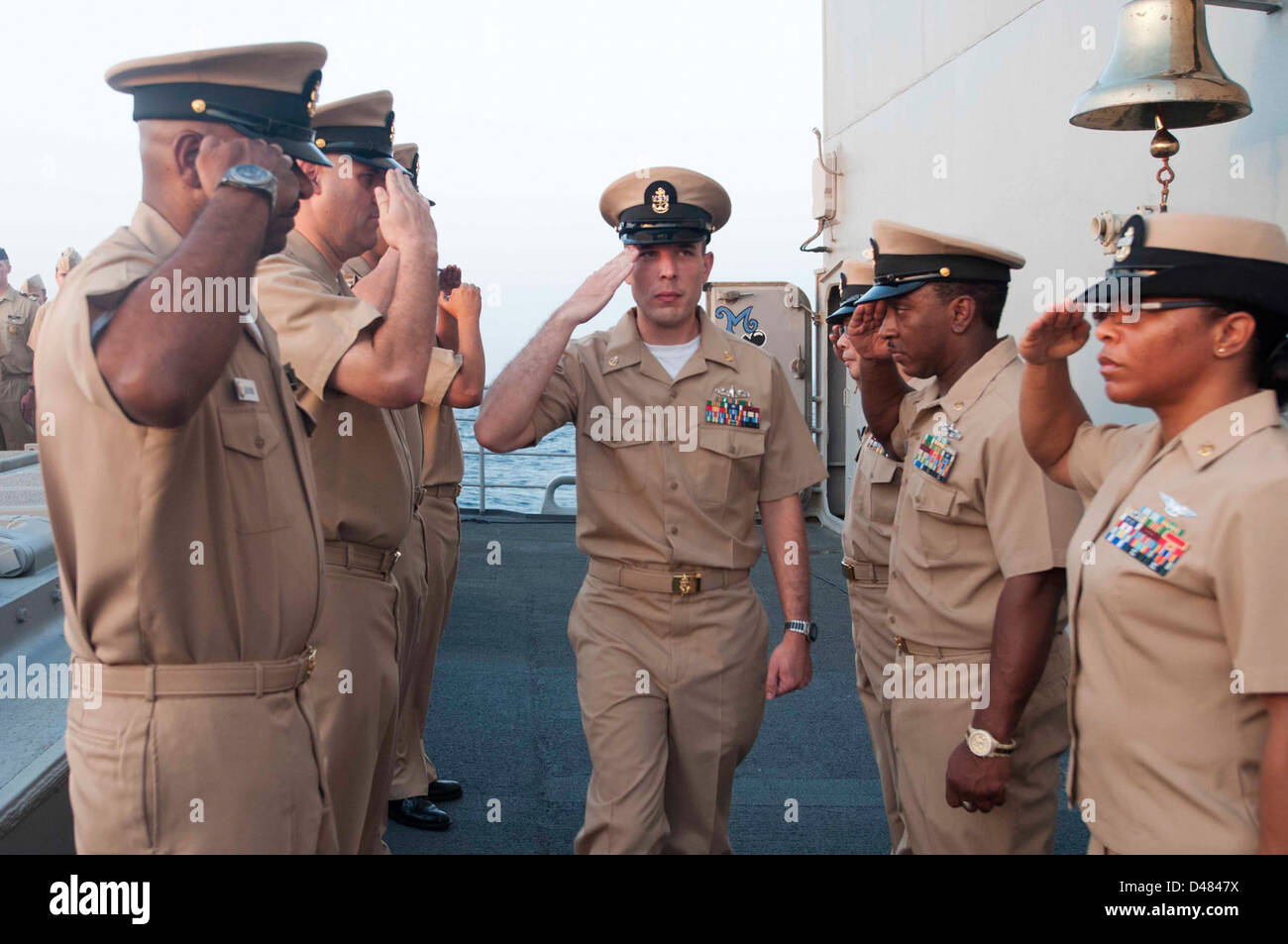 Sailors aboard the USS Hue City (CG 66) welcome a new chief to the ...