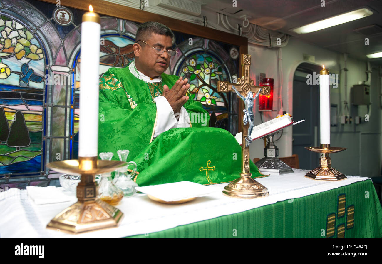 A Navy Chaplain conducts Mass for the crew aboard a U.S. Navy ship in ...