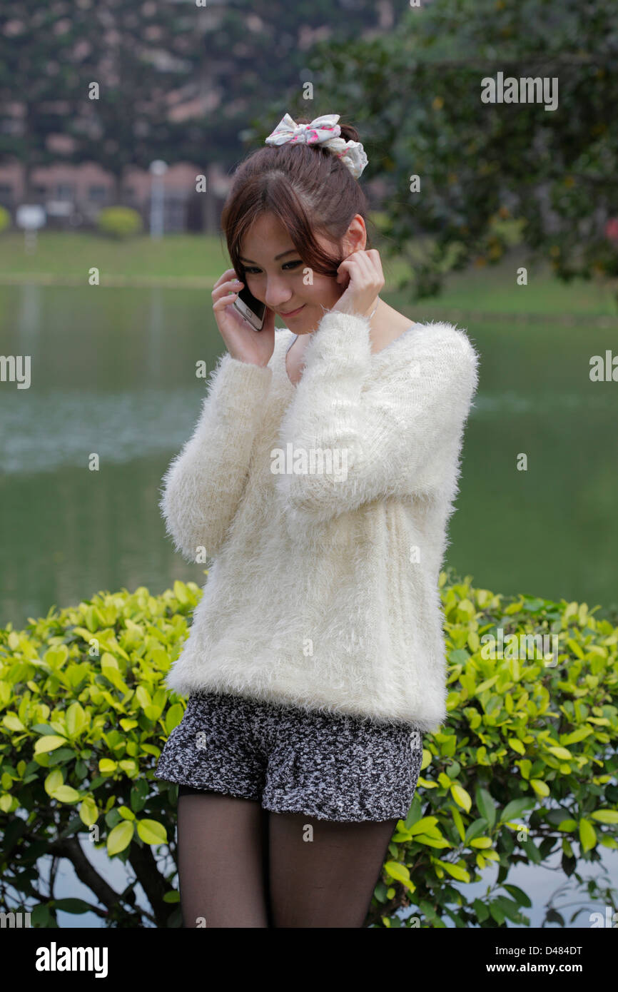 Girl student uses mobile-phone in university campus Stock Photo - Alamy