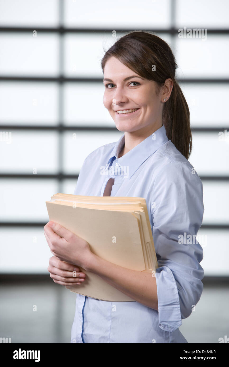 Business woman reading documents in modern office Stock Photo - Alamy