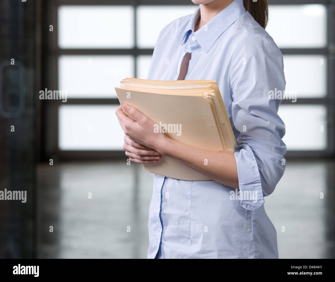 Business woman reading documents in modern office Stock Photo - Alamy