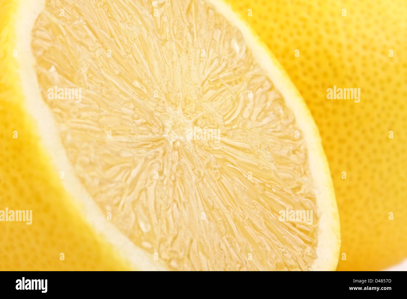 A fresh cutted lemon with another lemon in background Stock Photo - Alamy