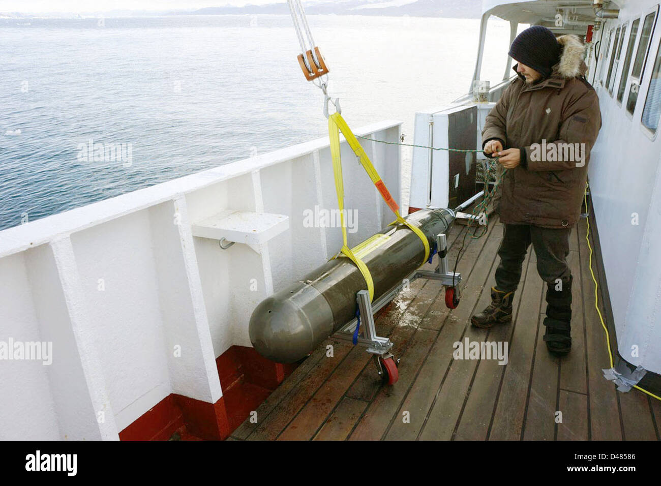An underwater vehicle is prepared for deployment under the Helheim ...