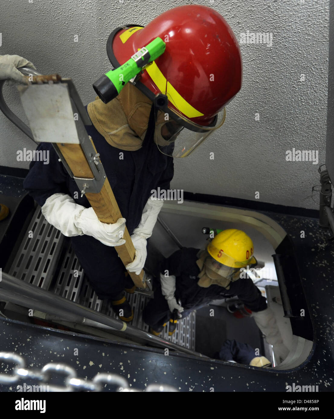 U.S. Navy sailors carry shoring gear down stairs aboard a ship in the ...