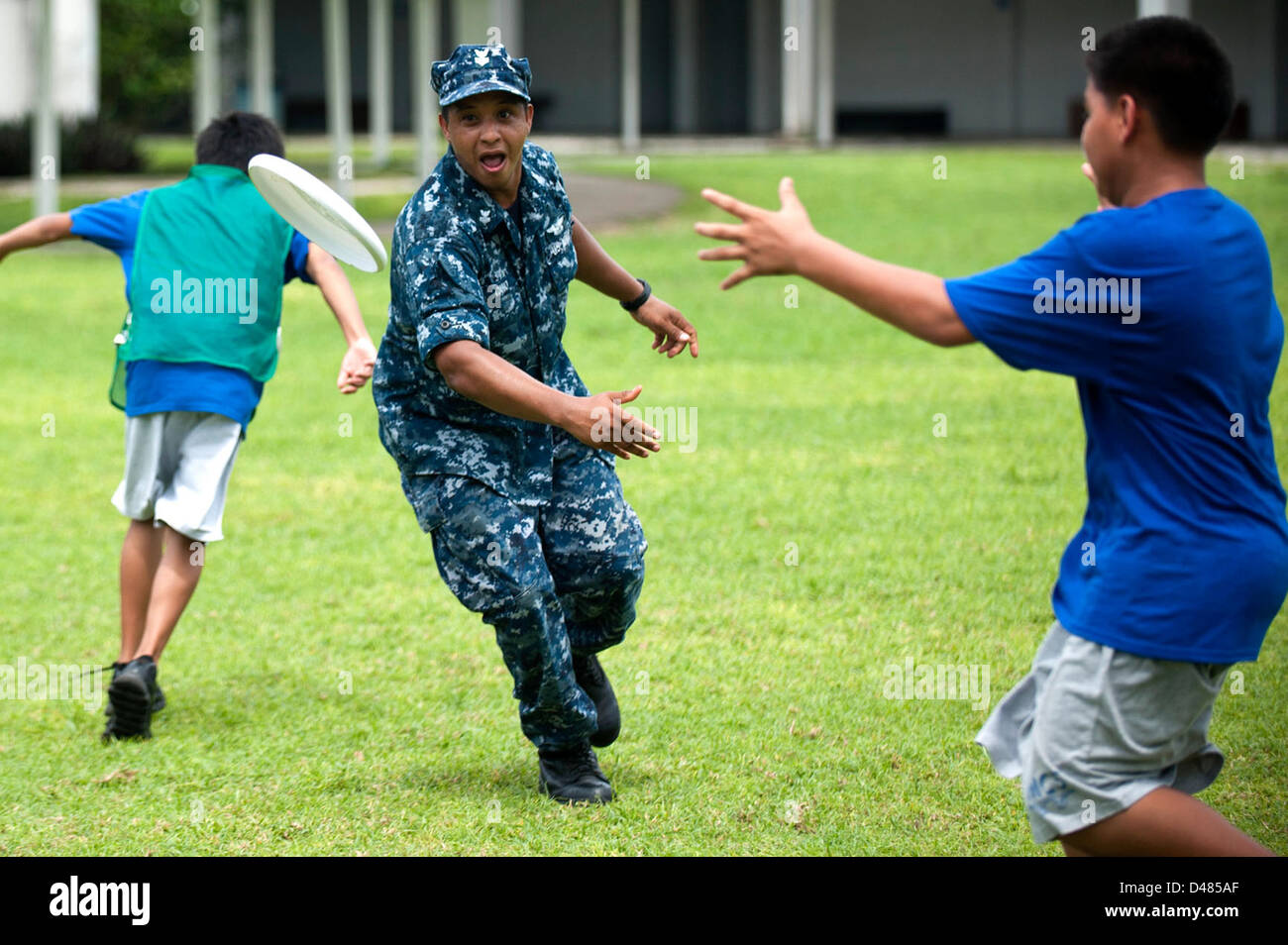 A U.S. Navy sailor participates in an ultimate frisbee game in Saipan ...