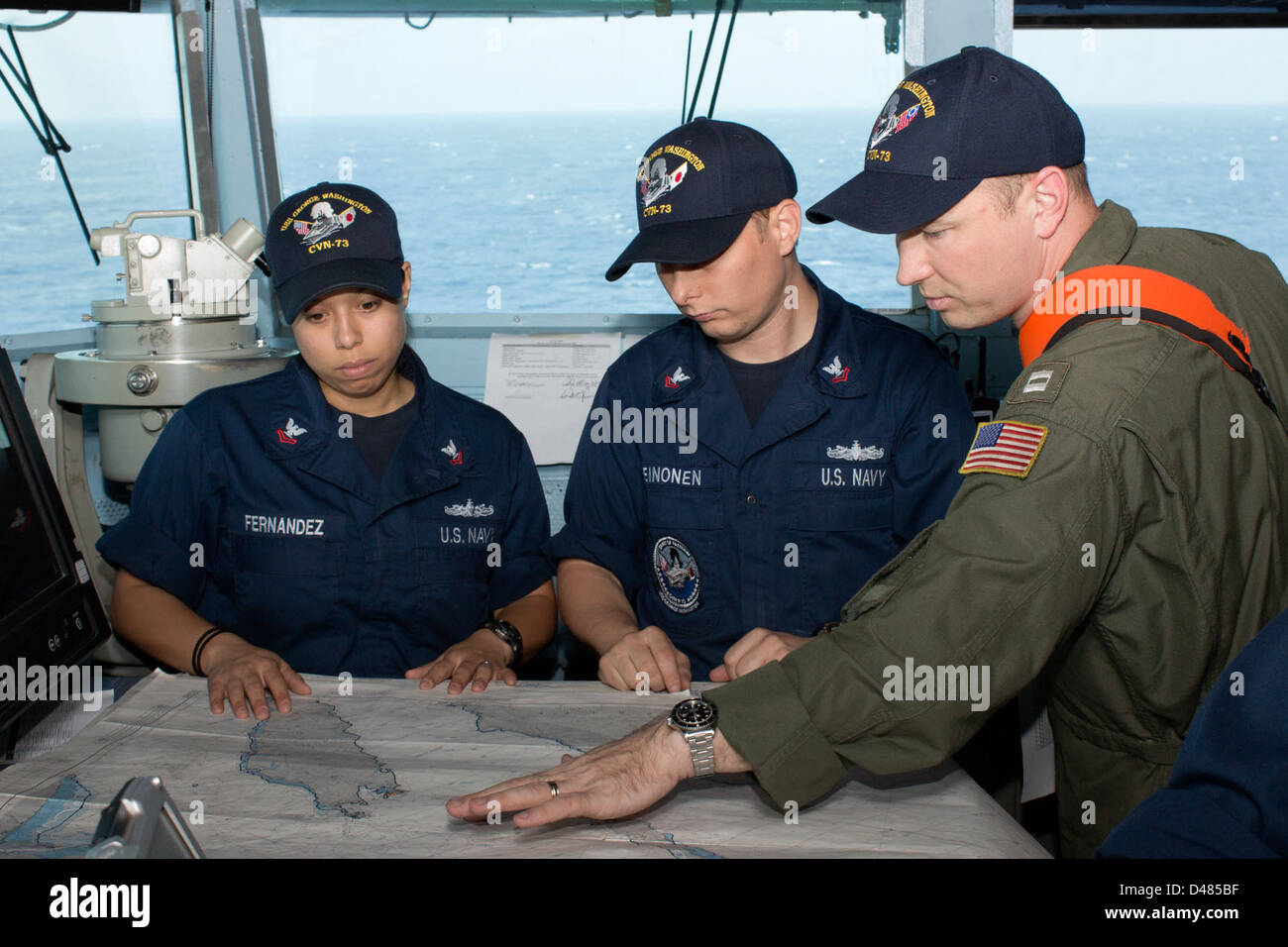 Sailors study a navigational chart Stock Photo - Alamy