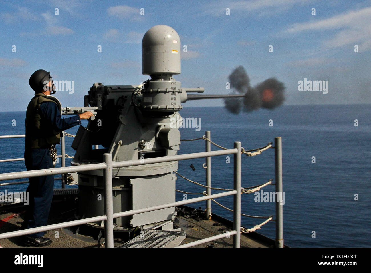The USS Boxer fires its 25mm machine gun in the Pacific Ocean during a ...