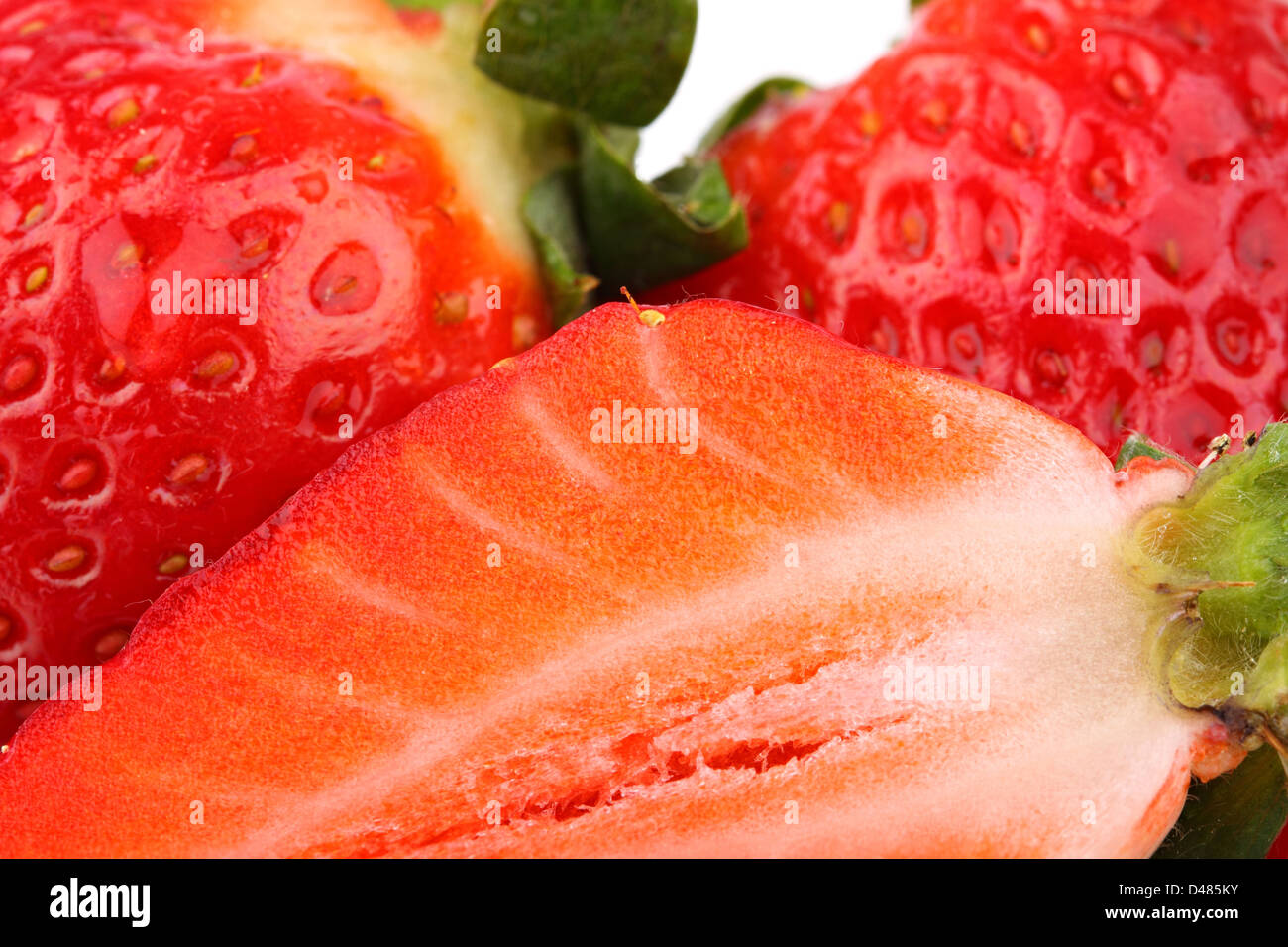 a closeup of slice of strawberry and whole fruits Stock Photo - Alamy
