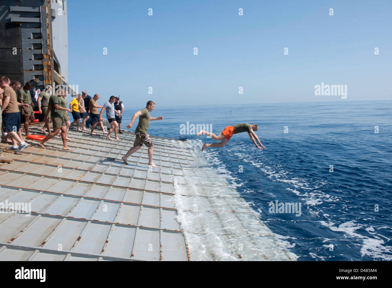 Sailors aboard the USS Fort McHenry enjoy a swim call in the ...