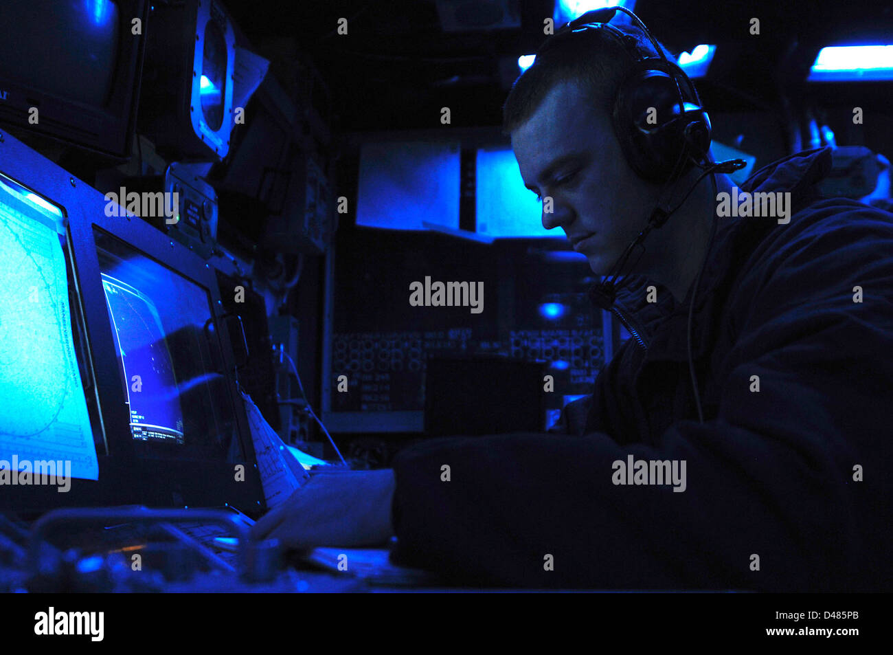 A U.S. Navy sailor logs flight operations aboard a ship in the Pacific ...