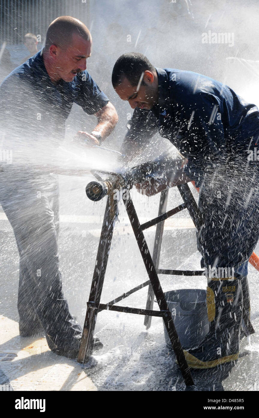 Sailors aboard the USS McFaul (DDG 74) practice pipe-patching ...