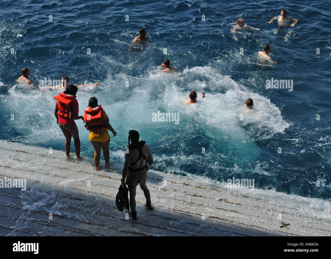 Sailors and Marines take part in a swim call in the Gulf of Aden as a ...