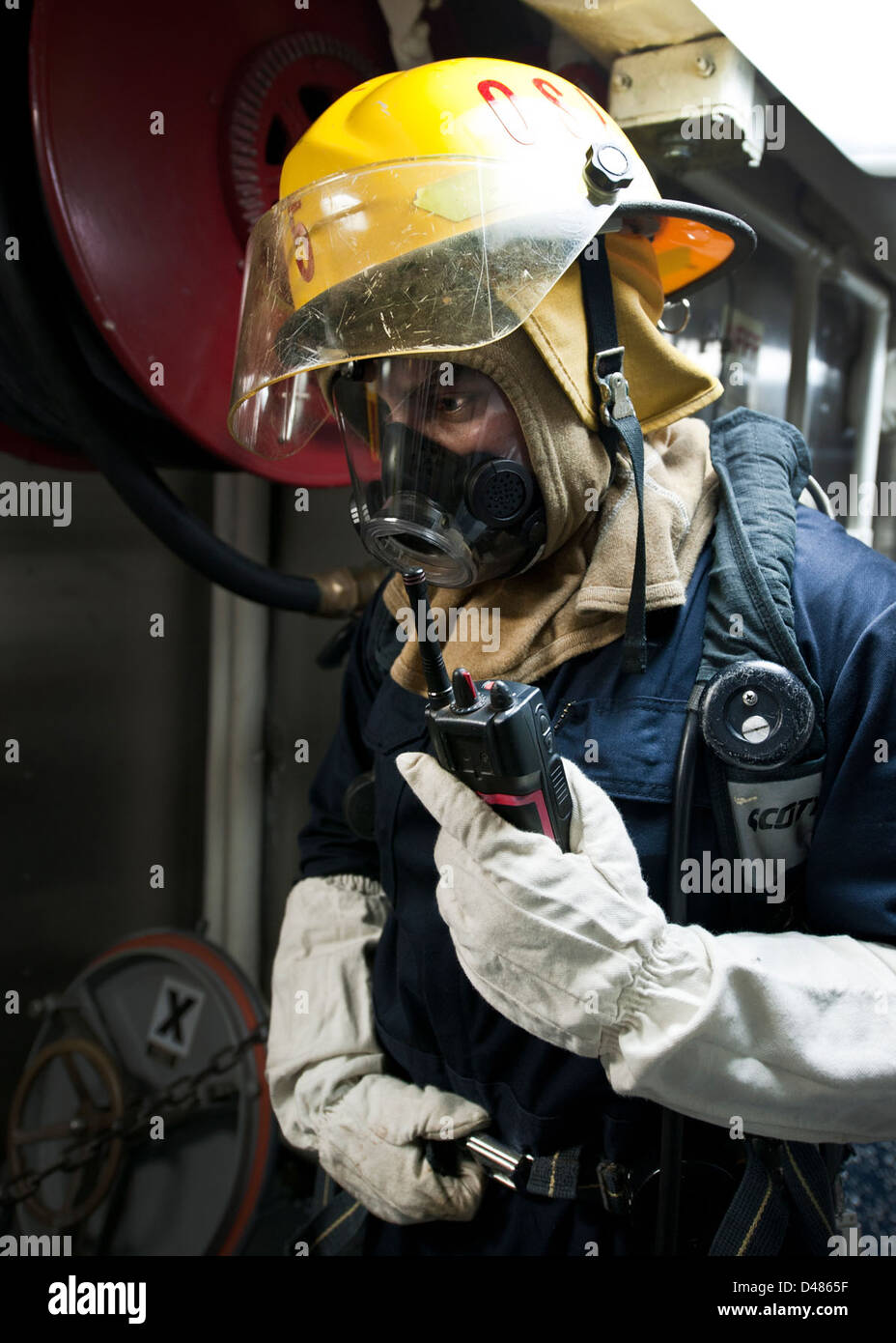 A Sailor operates a radio during a drill aboard a U.S. Navy vessel in ...