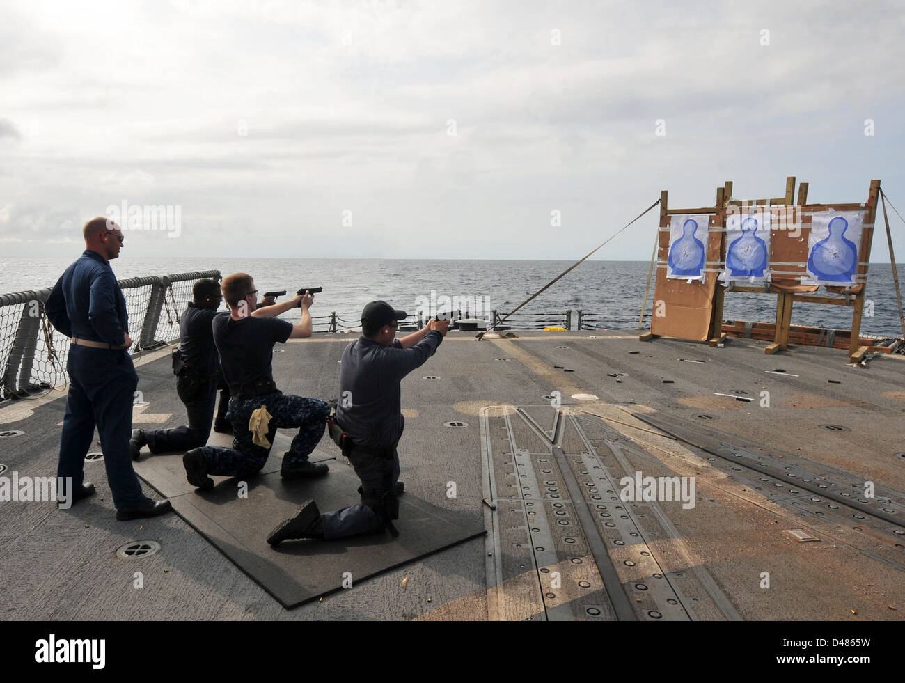 Sailors aboard a U.S. Navy ship in the Caribbean Sea qualify with ...
